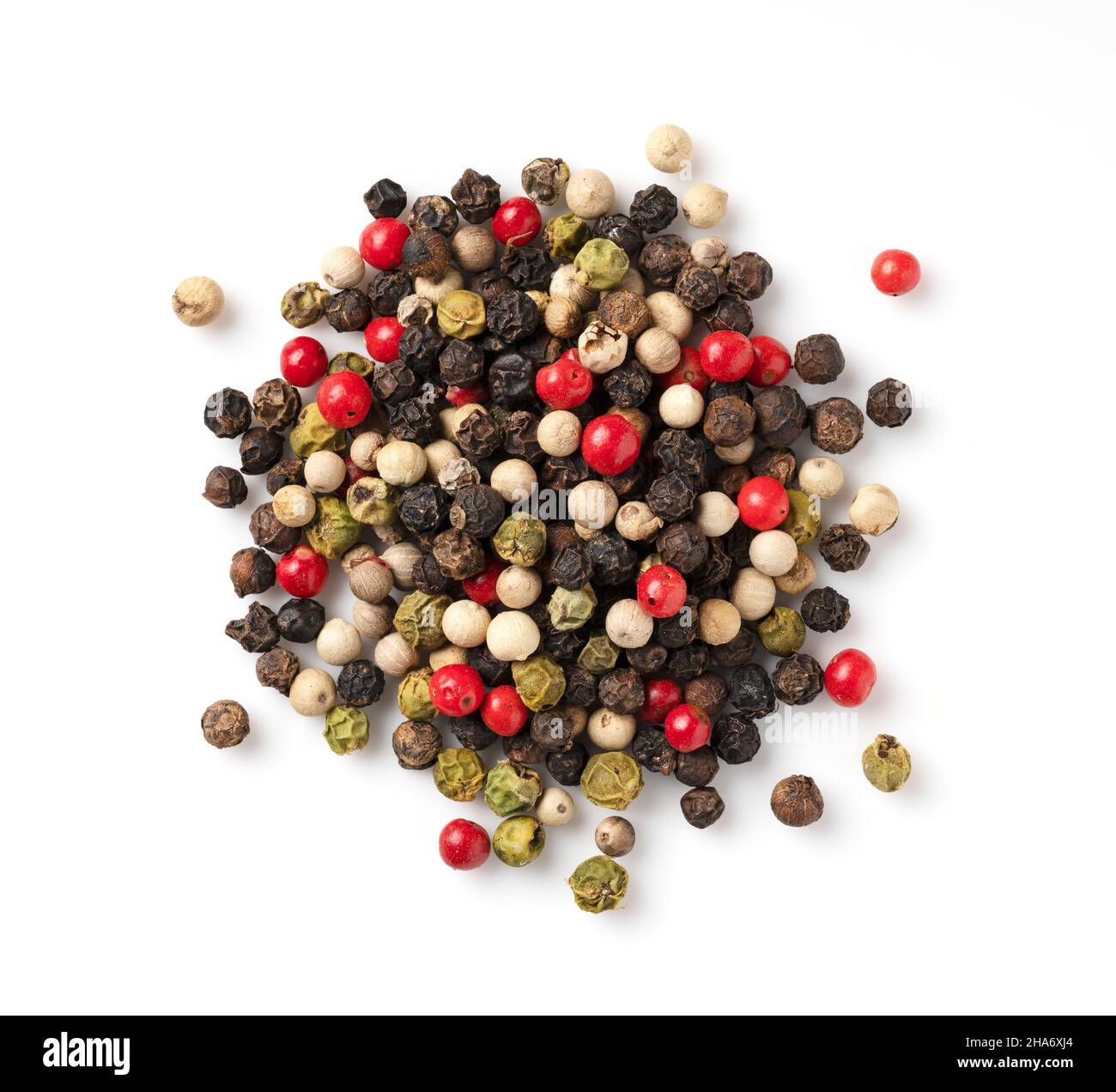 Pepper mix. Black, red, white, and green peppercorns on a white ...