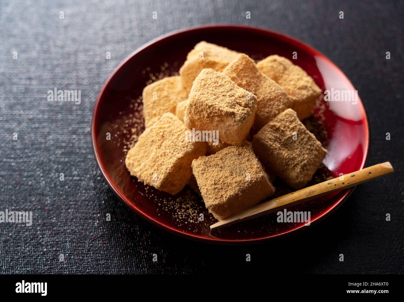Warabi mochi placed on a black Japanese tray. Warabimochi is a ...