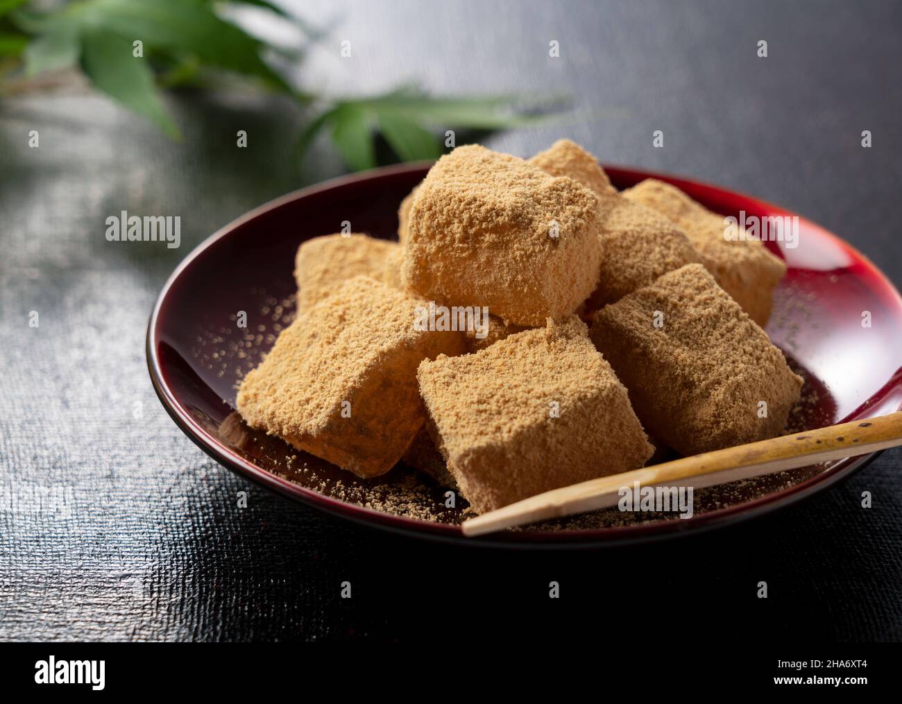 Warabi mochi placed on a black Japanese tray. Warabimochi is a ...