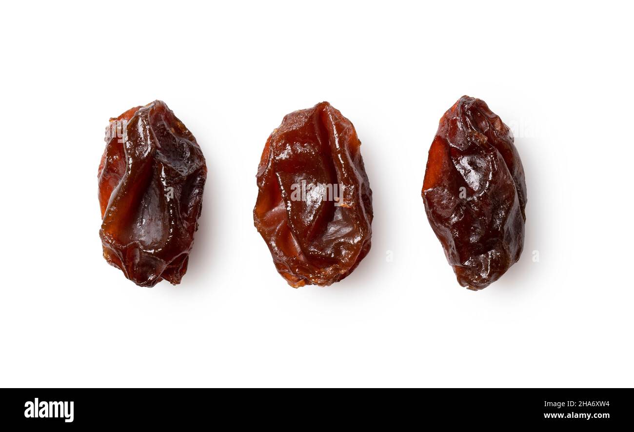 Three raisins on a white background. View from above Stock Photo - Alamy