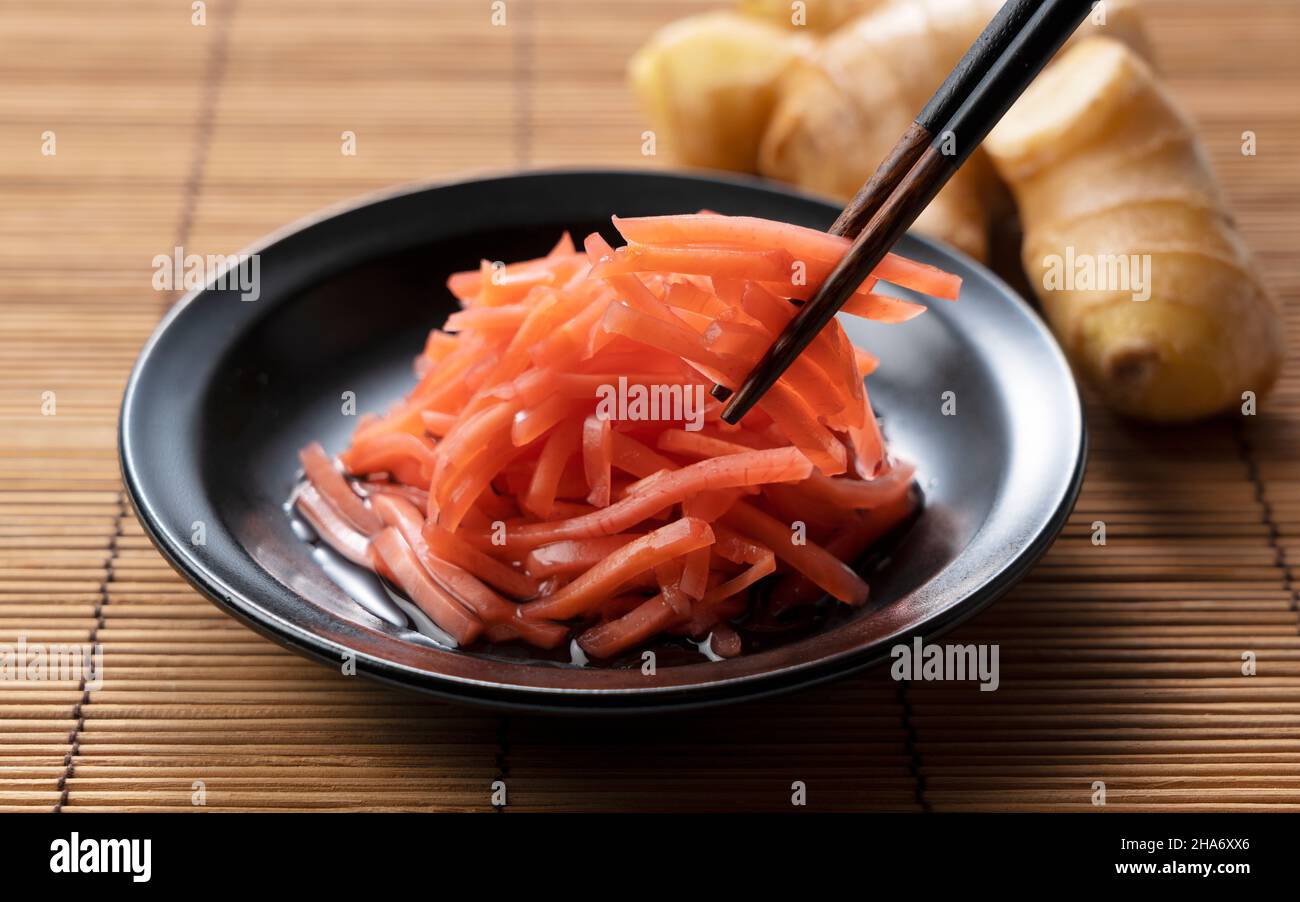 Red pickled ginger placed on a Japanese style background. Eating with ...