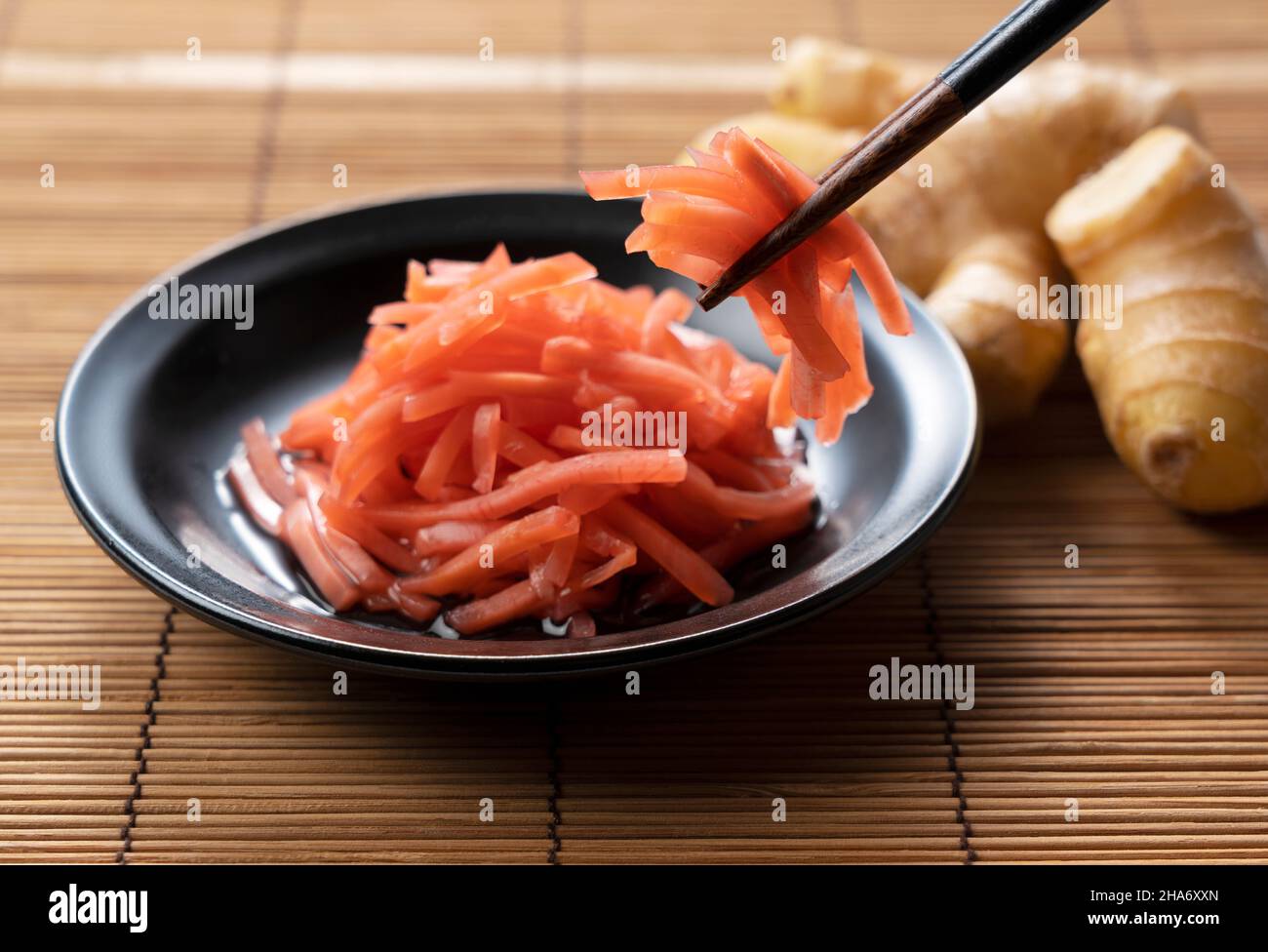 Red pickled ginger placed on a Japanese style background. Eating with ...