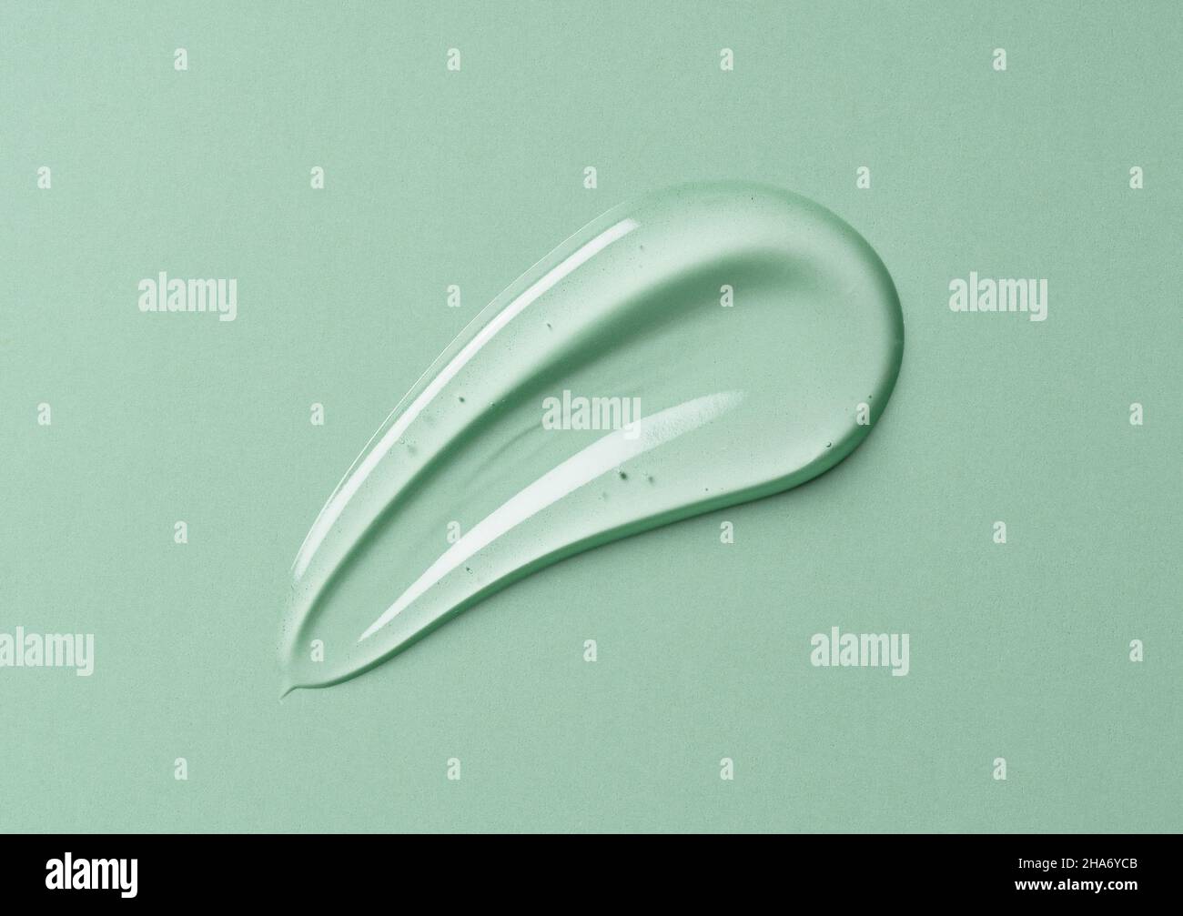 Transparent gel drop on green background. Liquid gel cosmetic stain ...