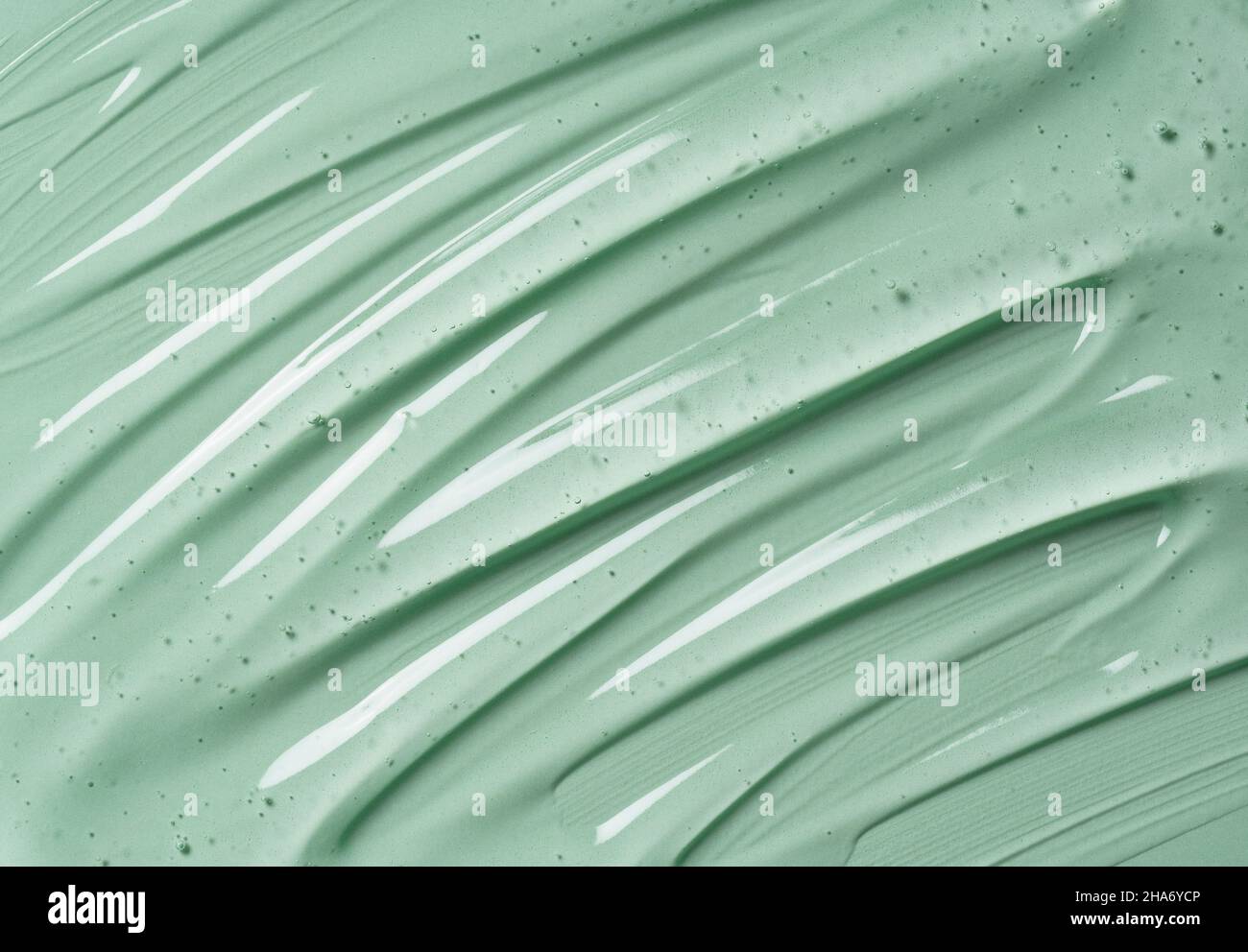 Serum texture on transparent liquid gel background with green ...