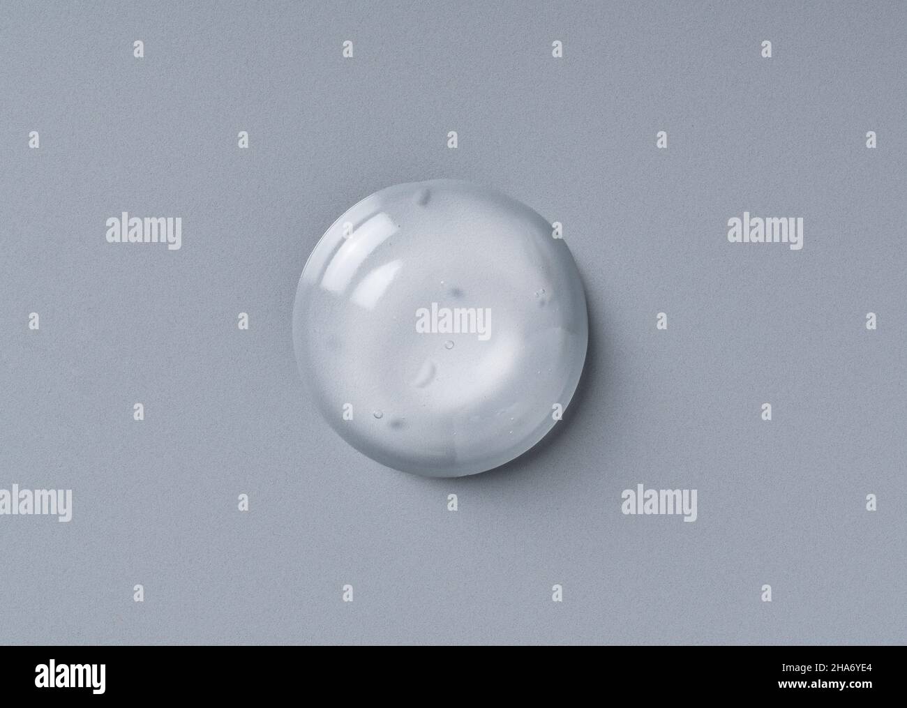 Transparent gel drop on gray background. Liquid gel texture. Beauty ...