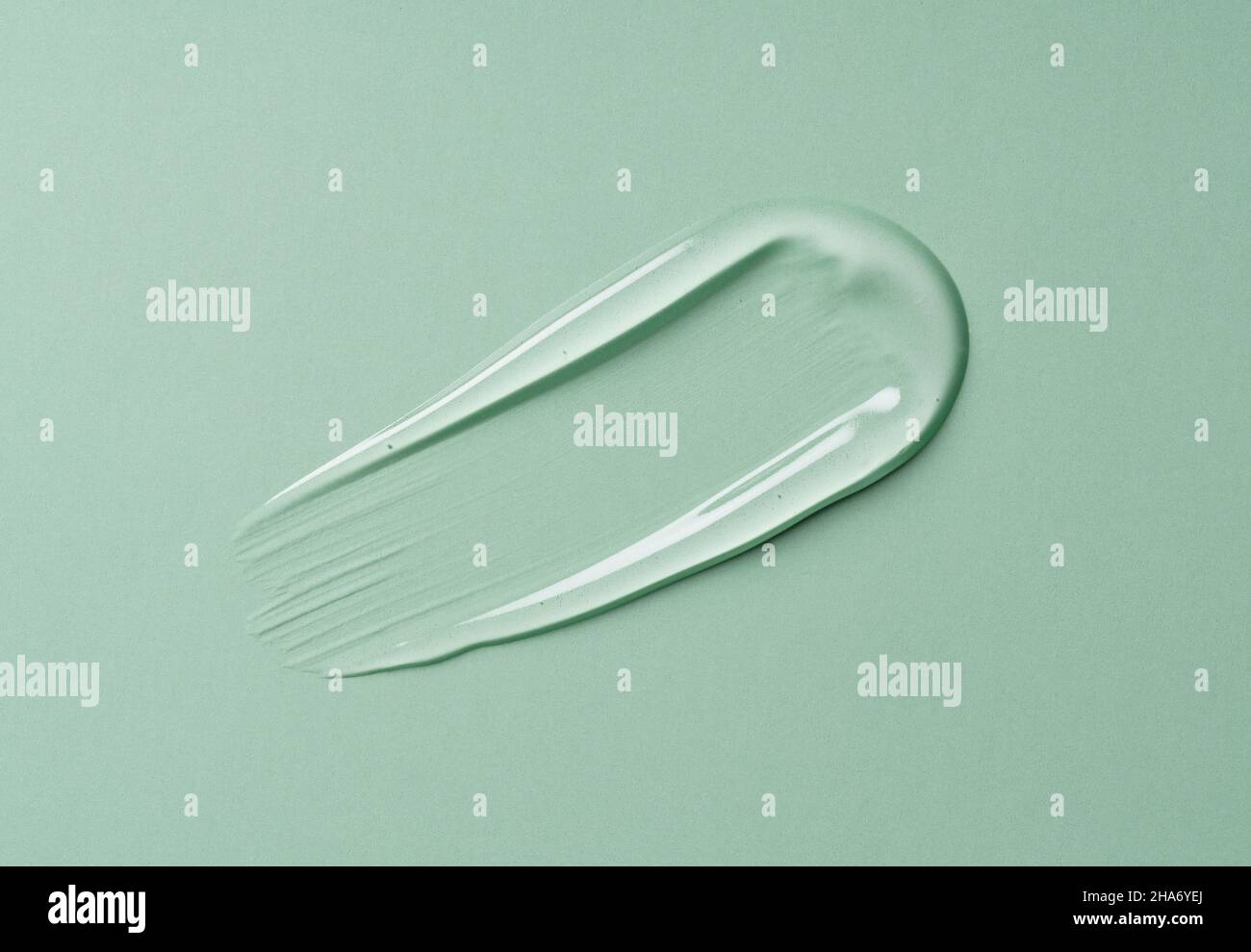 Transparent gel drop on green background. Liquid gel cosmetic stain ...