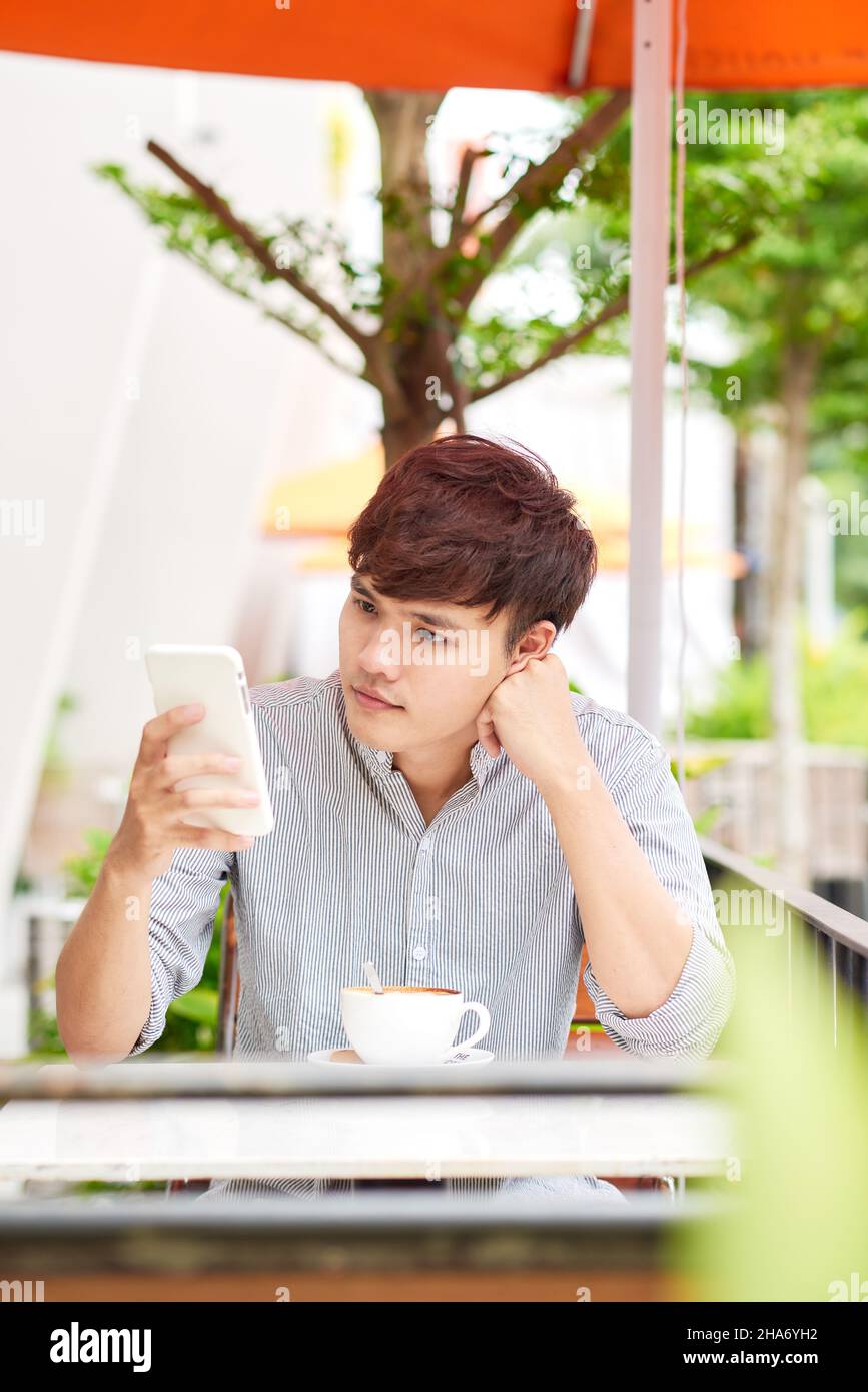 businessman using his smartphone while working remotely from a modern ...