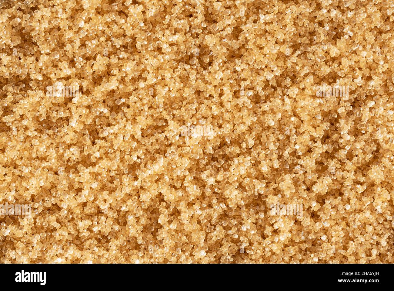 A close-up of brown sugar across the screen. View from directly above ...