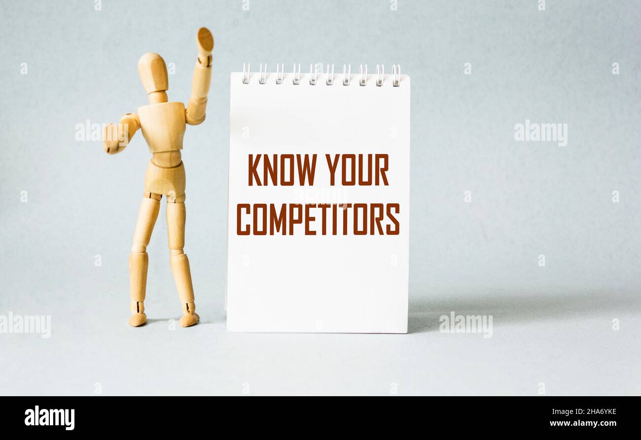 Notepad with the text KNOW YOUR COMPETITORS on a white background with ...