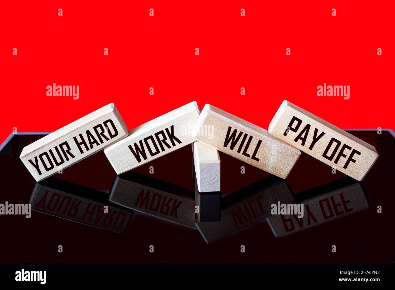 Text Your hard work will pay off on wood blocks and red and black ...