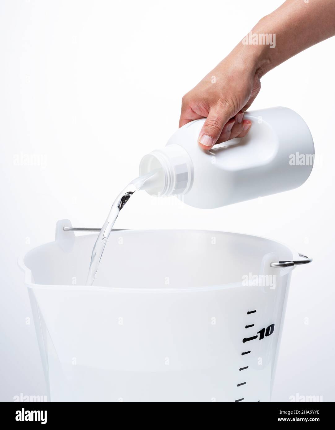 Pour the detergent into the bucket Stock Photo - Alamy