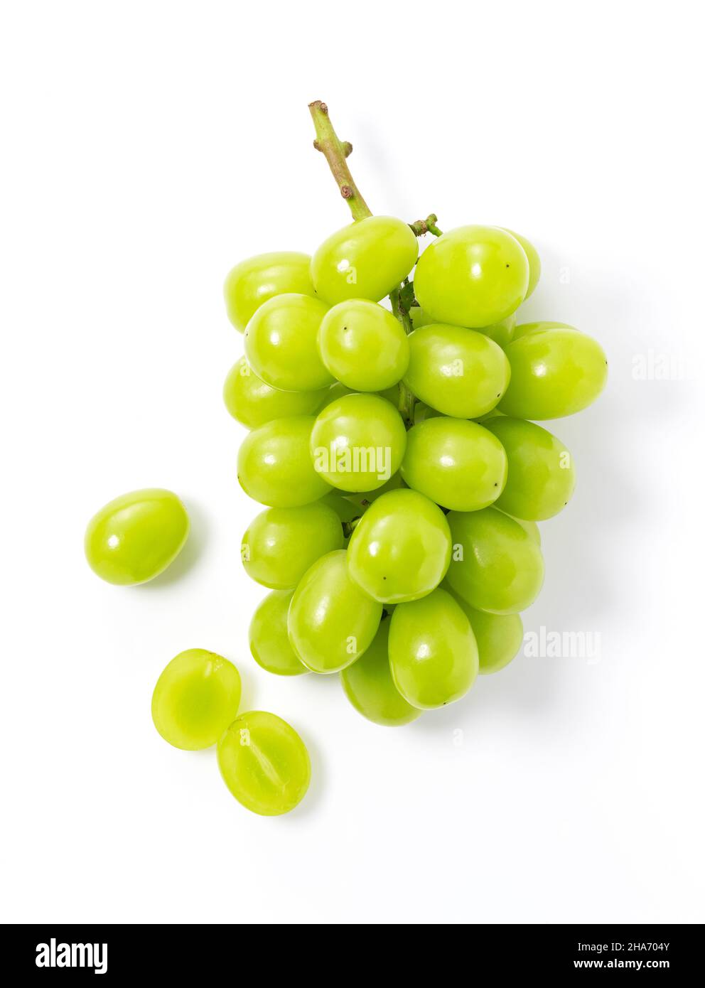 Bunches of Shine-Muscat grapes and cut Shine-Muscat grapes on a white ...