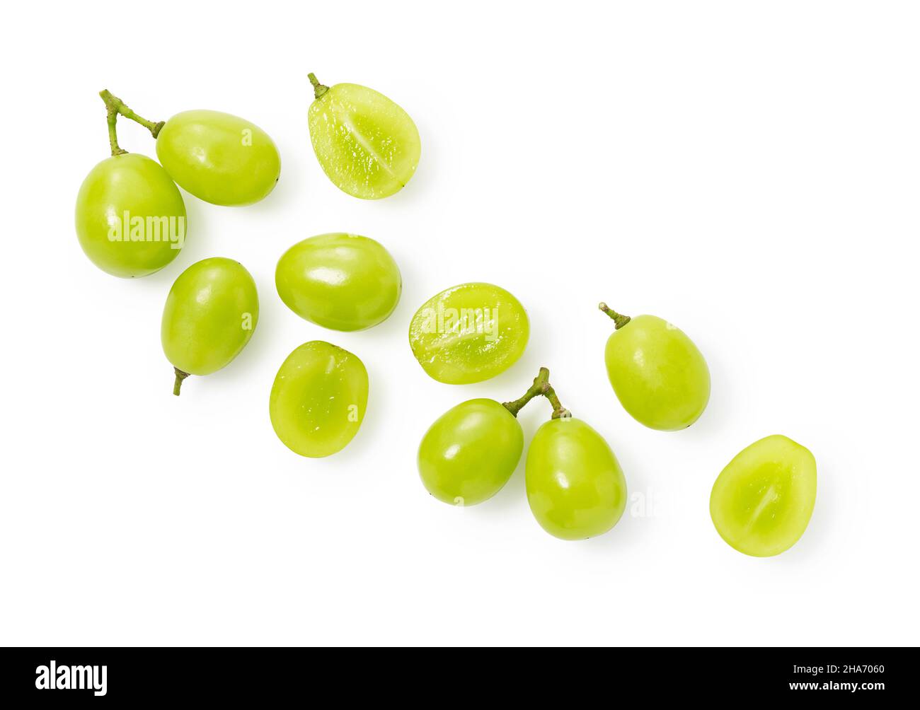 A lot of Shine-Muscat grapes and cut Shine-Muscat grapes on a white ...