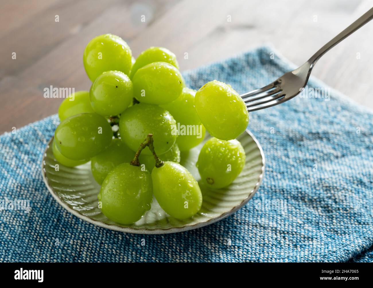 Eating a forkful of Shine Muscat grapes with a drop of water on the ...