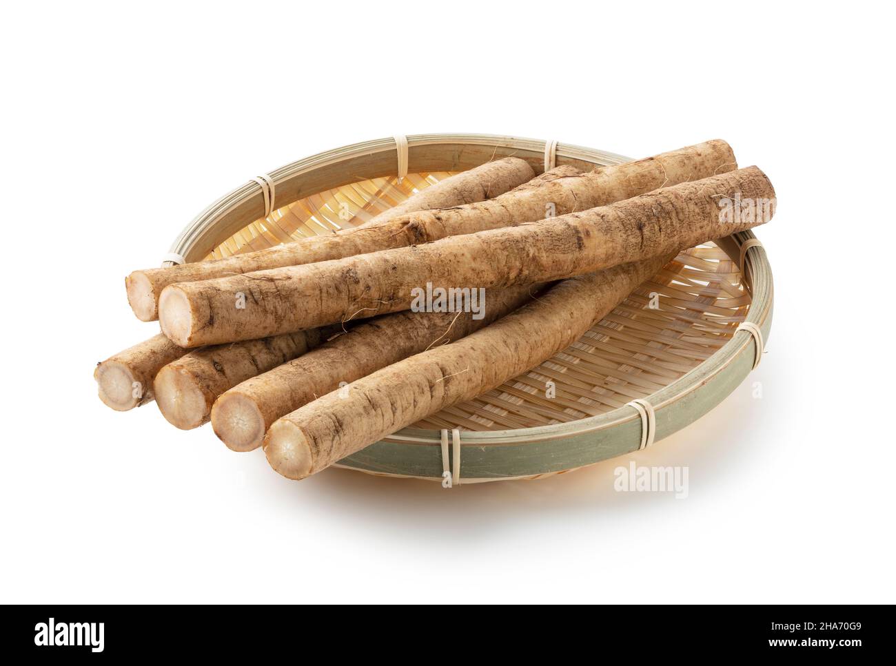 Burdock in a bamboo basket on a white background Stock Photo - Alamy