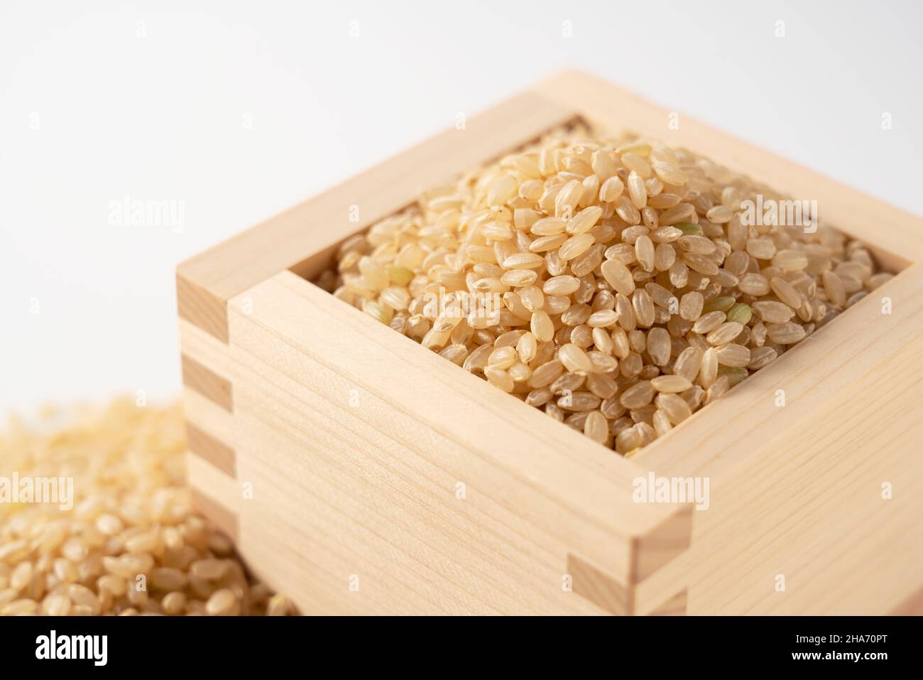 Brown rice in a wooden box set against a white background Stock Photo ...