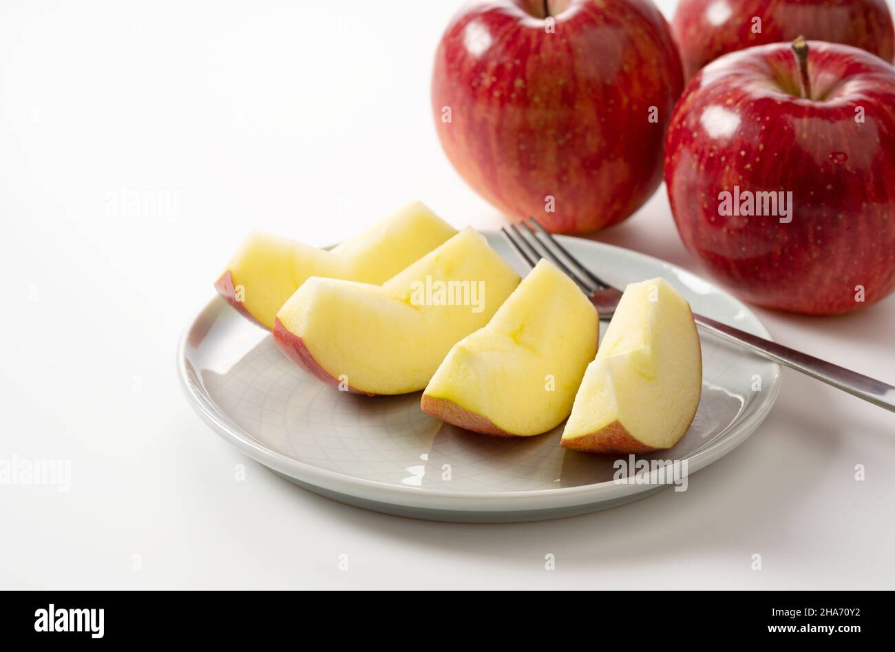 Cut apples on a plate against a white background. Dessert, diet image ...