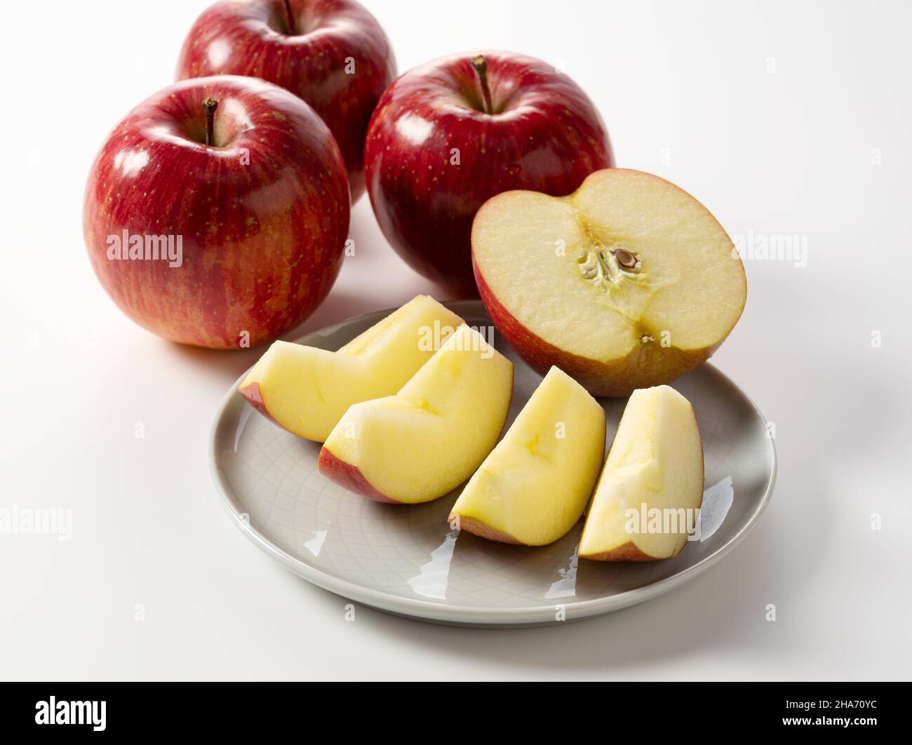 Cut apples on a plate against a white background. Dessert, diet image ...