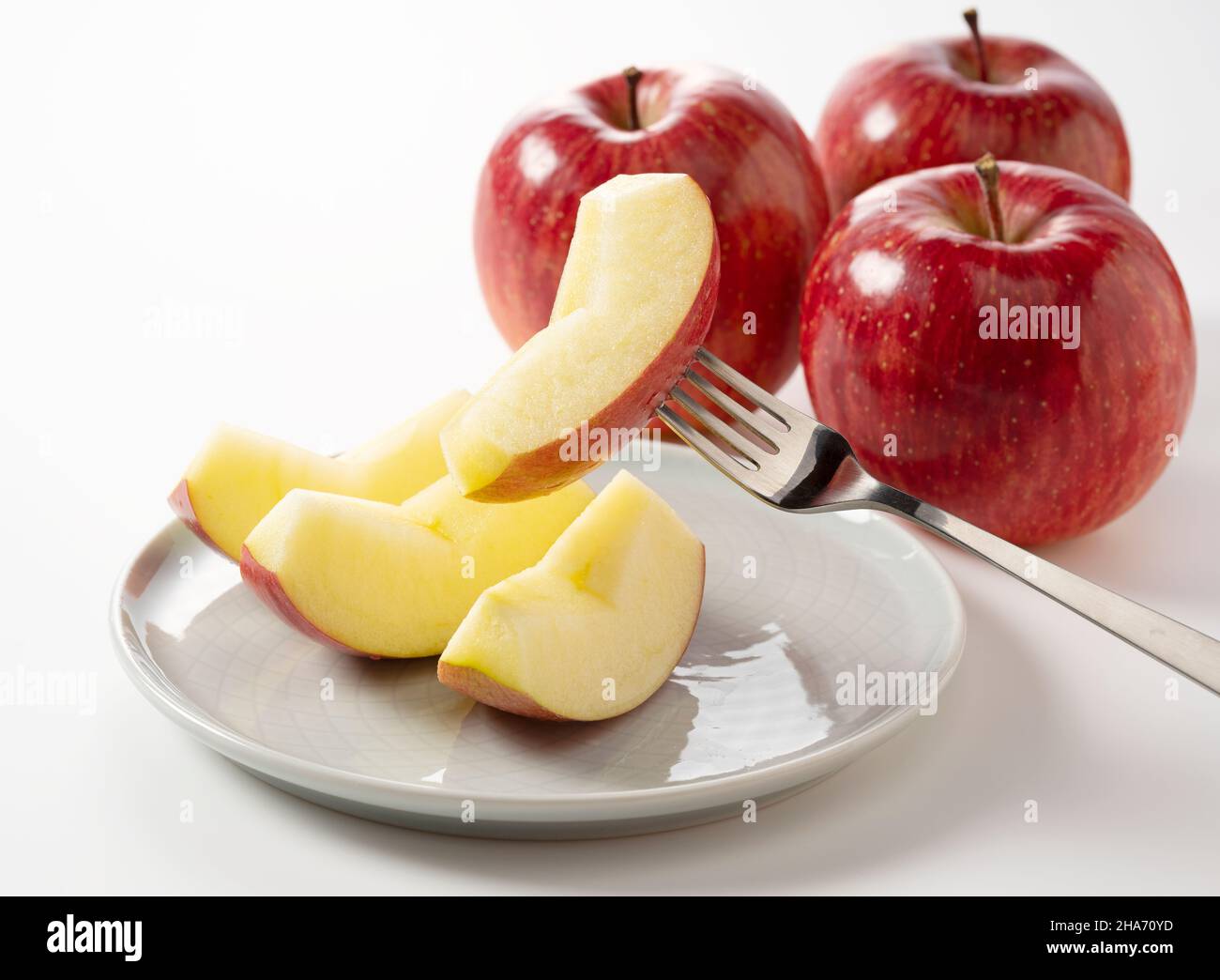 Cut apples on a plate against a white background. Dessert, diet image ...
