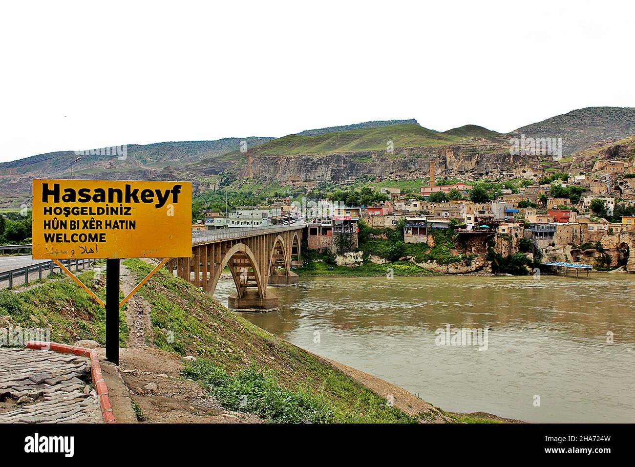 Yellow sign with a text WELCOM in different languages on a bridge pier ...