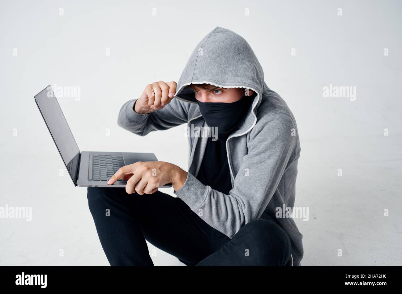male thief hooded head hacking technology security isolated background ...