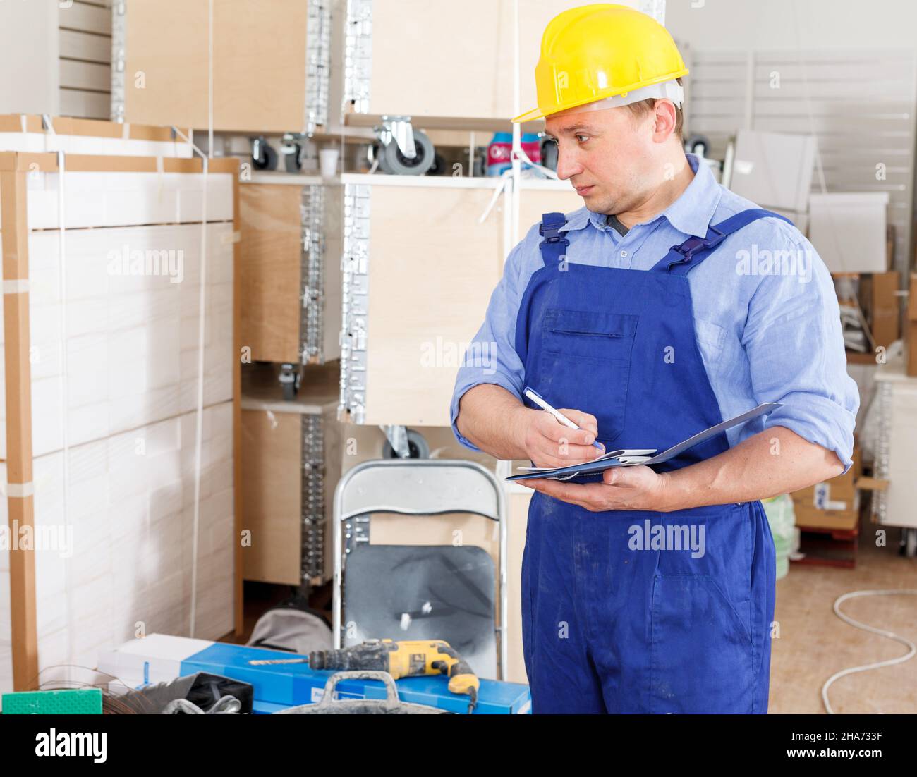 Professional builder getting ready for repair works indoors, making ...