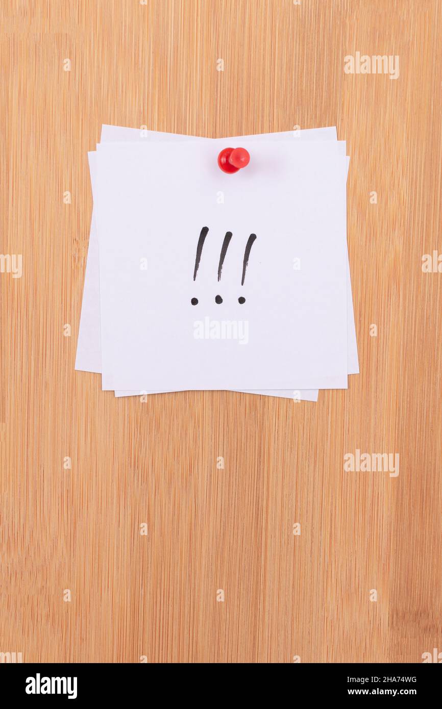 White Sticky Notes with Three Exclamation Points Pinned to the Wooden ...