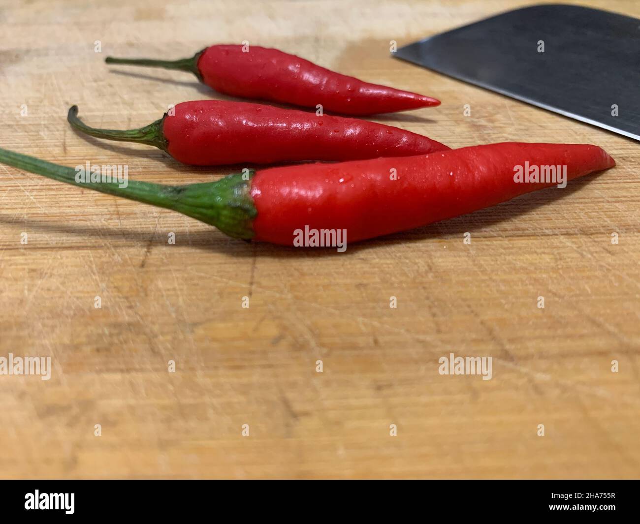 Chili to be chopped with sharp knife. Preparation for Asian food Stock ...