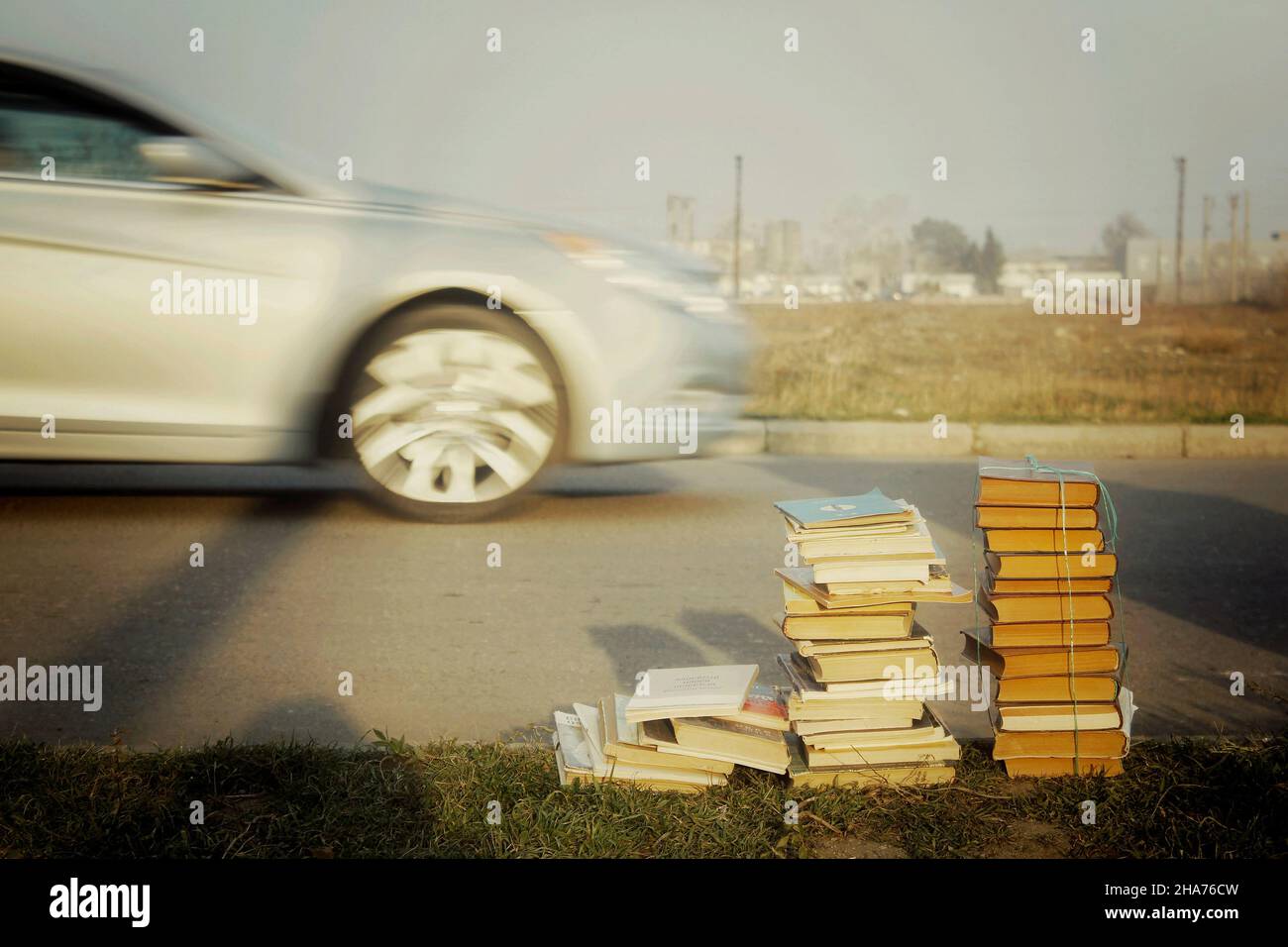 Thrown away bunch of old books lying by the road on the grass Stock ...