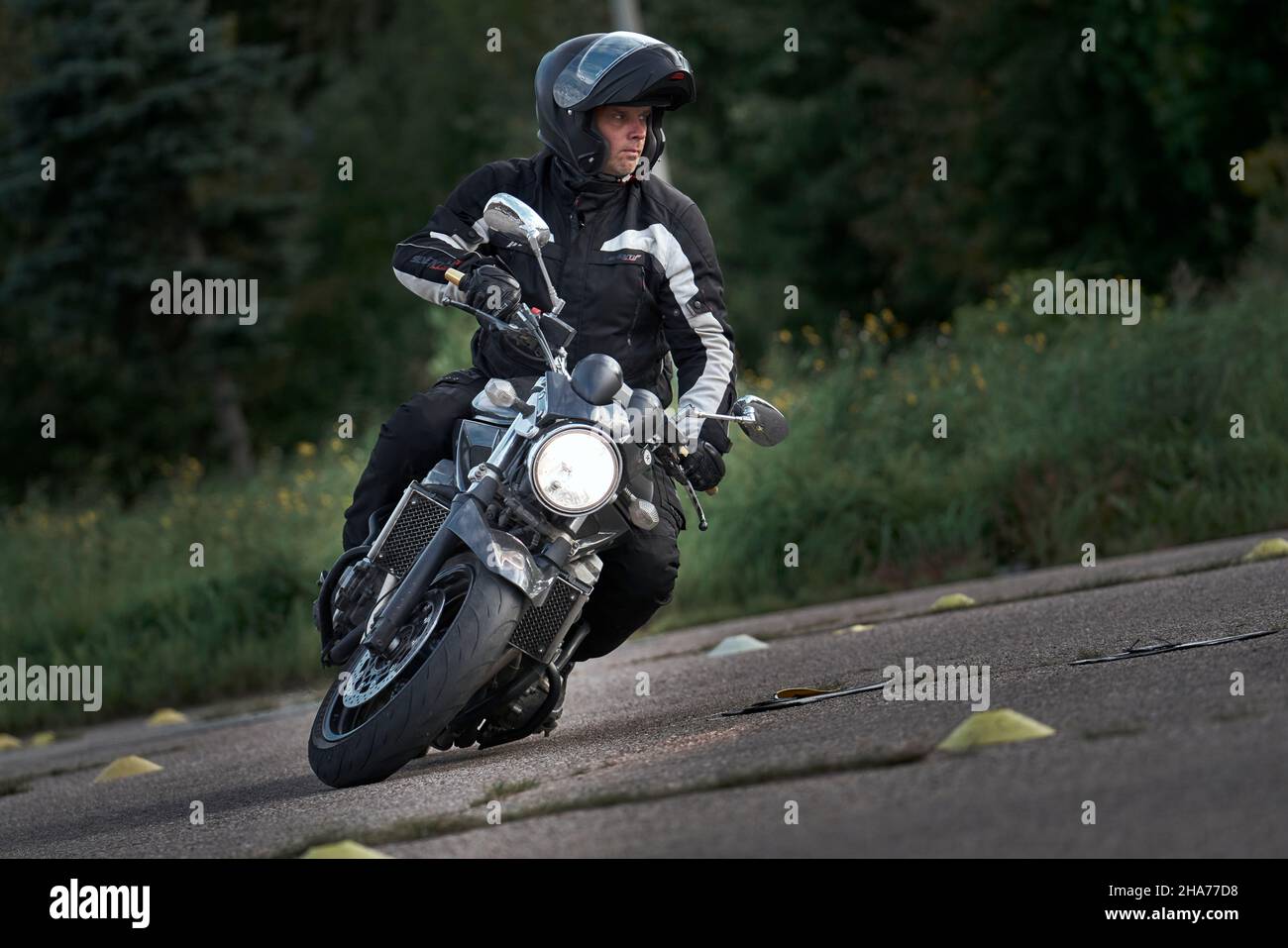 19-09-2021 Riga, Latvia A young man riding a motorcycle on an open road ...