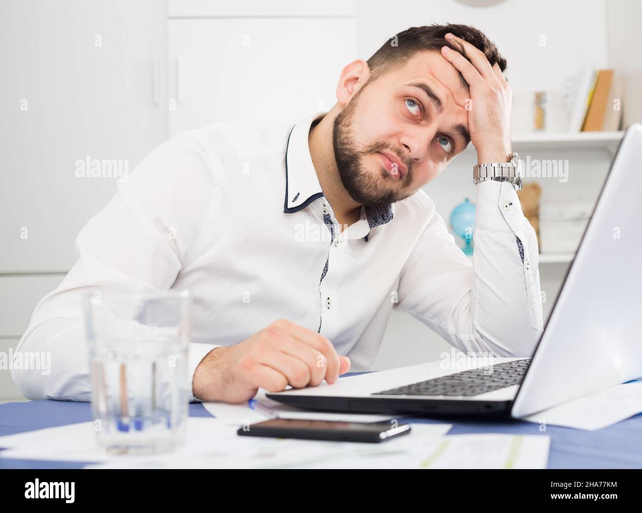 Stressed man worker facing challenge in project in office Stock Photo ...