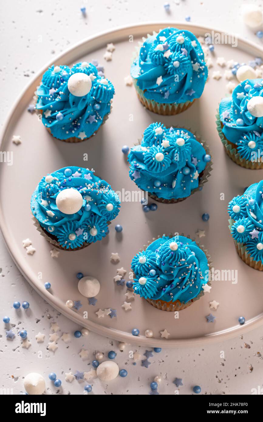 Beautiful cupcakes with blue whipped cream ready to eat. Perfect blue ...