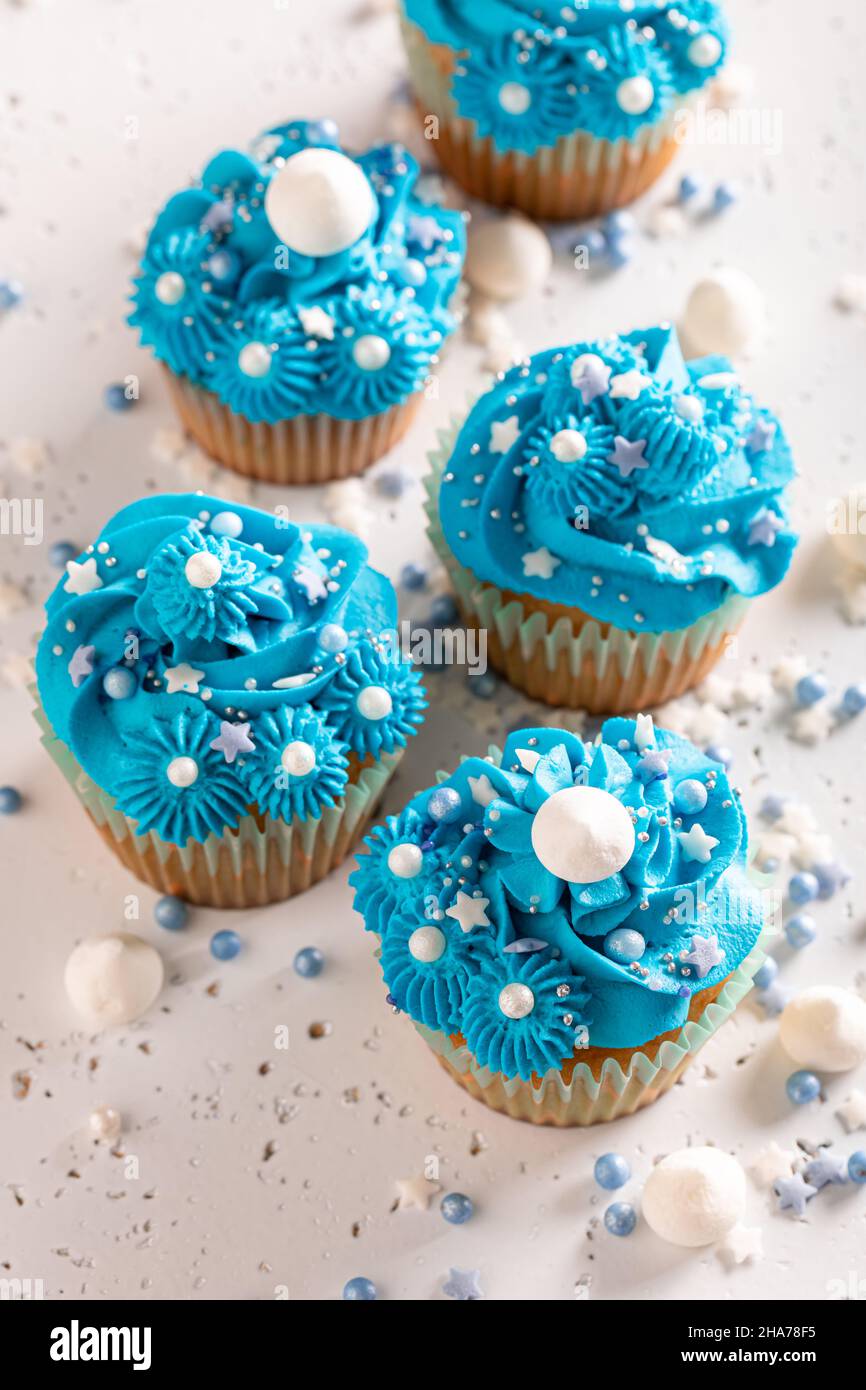 Unique cupcakes with blue whipped cream ready to eat. Perfect blue ...