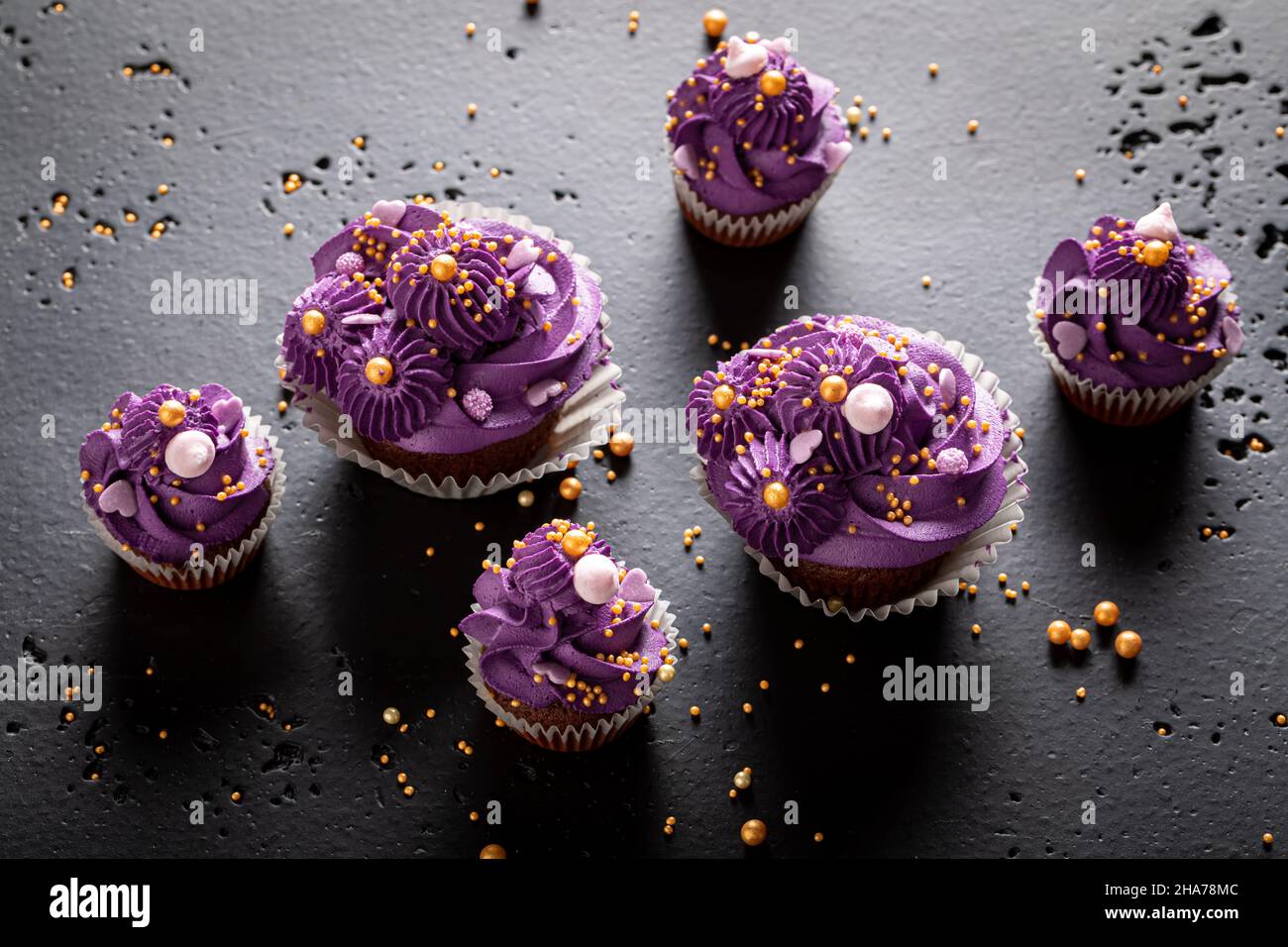 Beautiful cupcakes with flower shaped purple cream. Magnificent purple ...