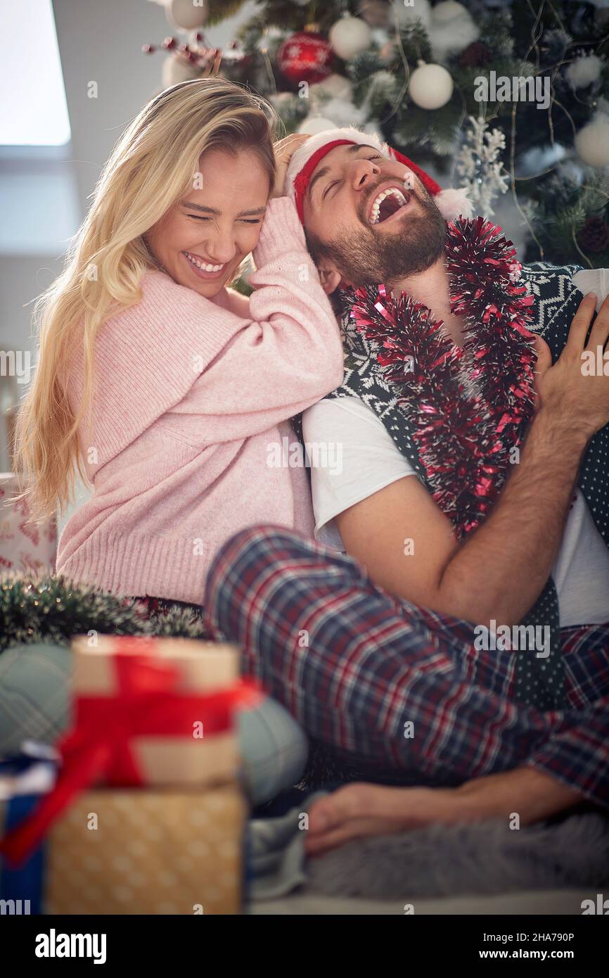 A guy is having a good time with his girlfriend while they are sitting ...