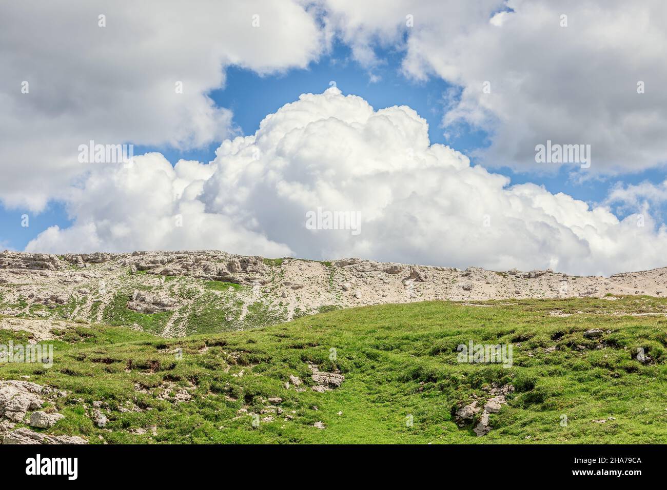 A beautiful landscape of an alpine plateau and cumulus clouds above it ...