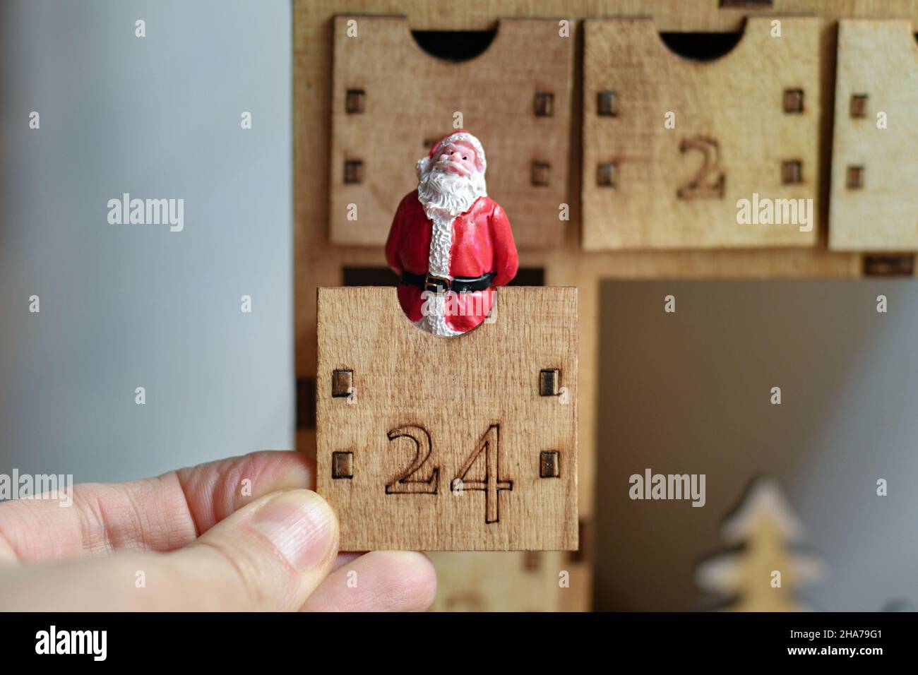 Hand opens wooden advent calendar Stock Photo - Alamy
