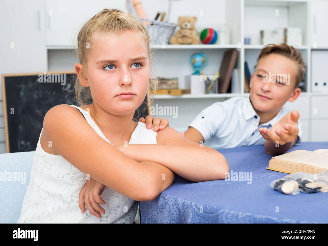 Brother is asking forgiveness from his offendedly sister at home Stock ...
