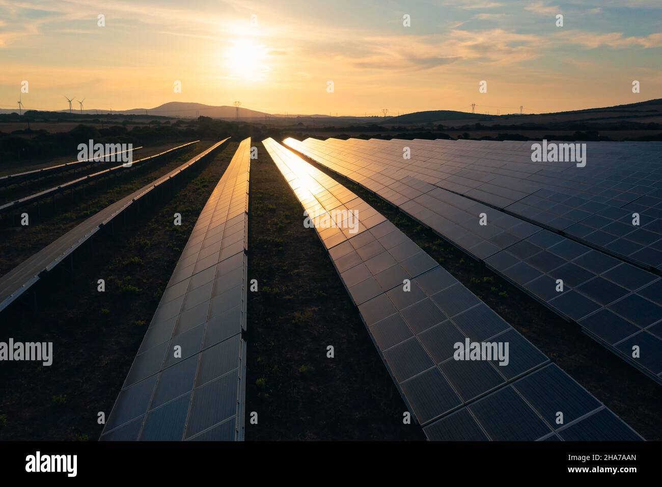 Solar panel farm under sunset sky reflecting light Stock Photo - Alamy