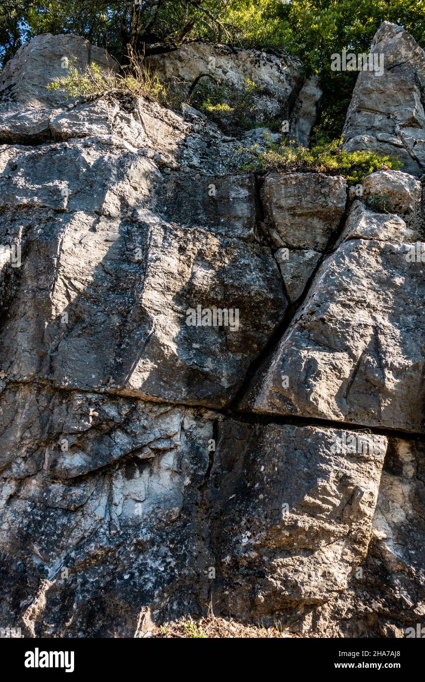 man-made stone wall built into cliff rock face Stock Photo - Alamy