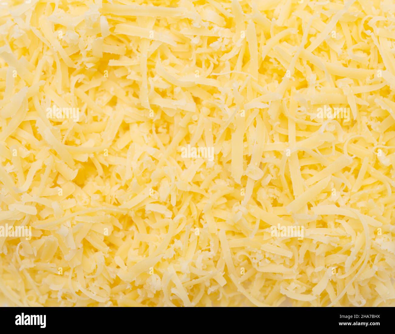 Grated cheese background Stock Photo - Alamy