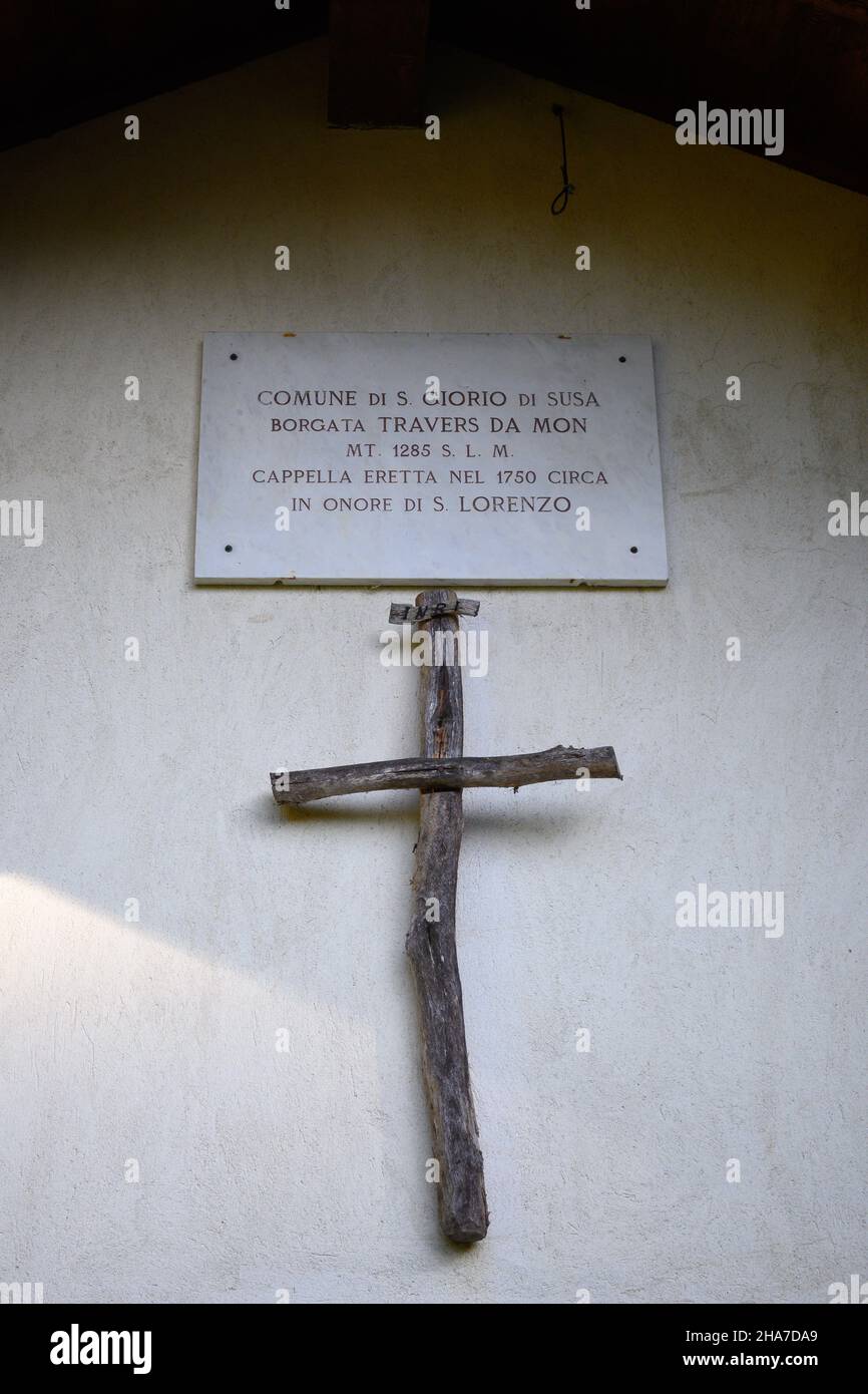 Small wooden cross placed on the facade of a mountain church Stock ...