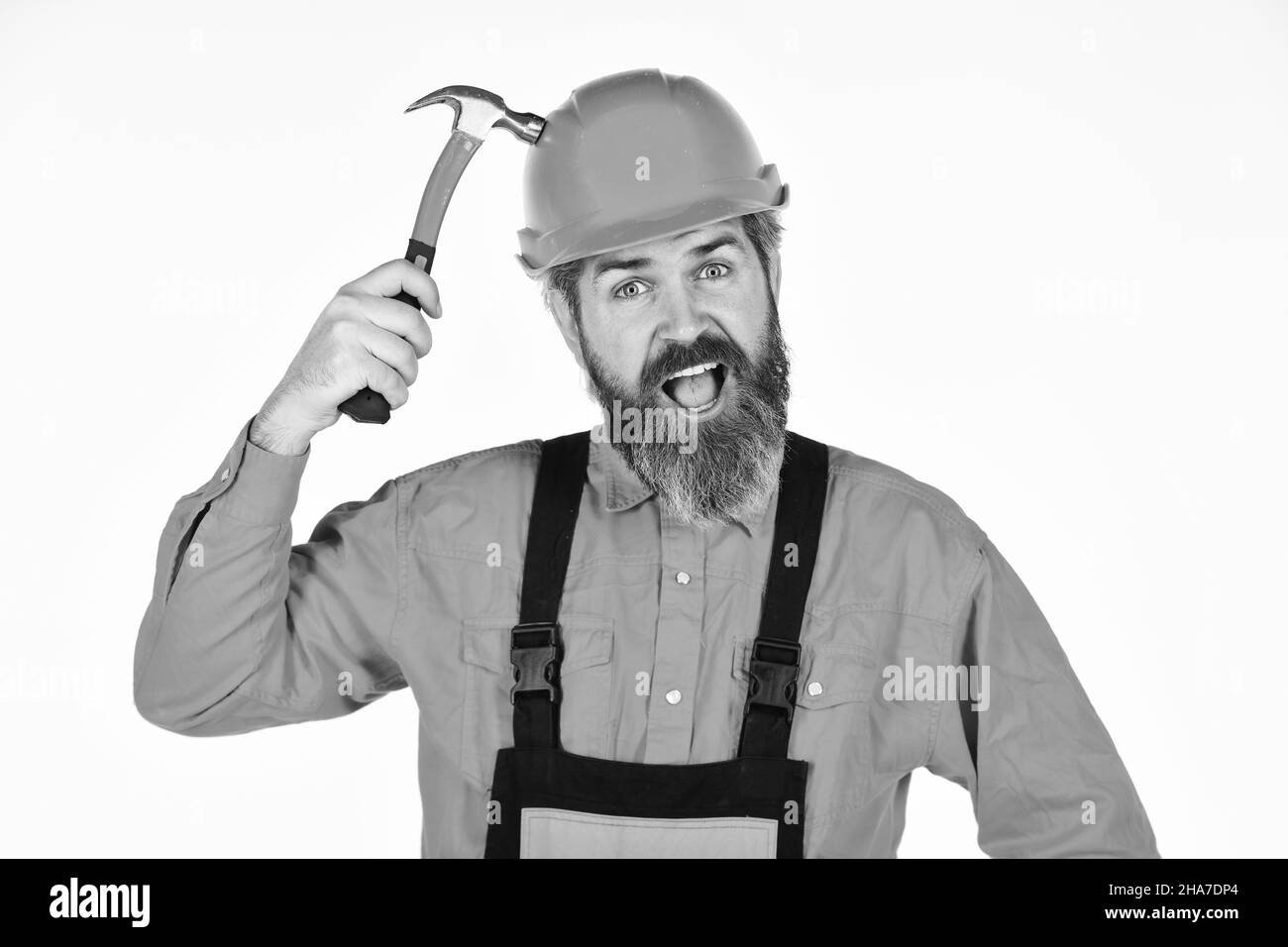 Impulse for changes. Bearded mature man in uniform. Guy with hammer ...