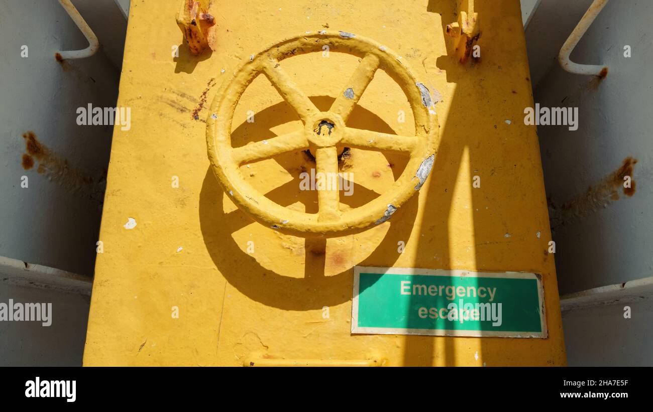 Closeup of a yellow emergency door at a ship Stock Photo - Alamy