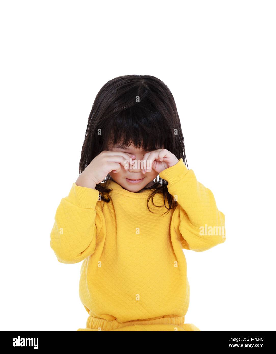 Chinese child waking up, girl looks sleepy in the morning, isolated on white background. A tired ...