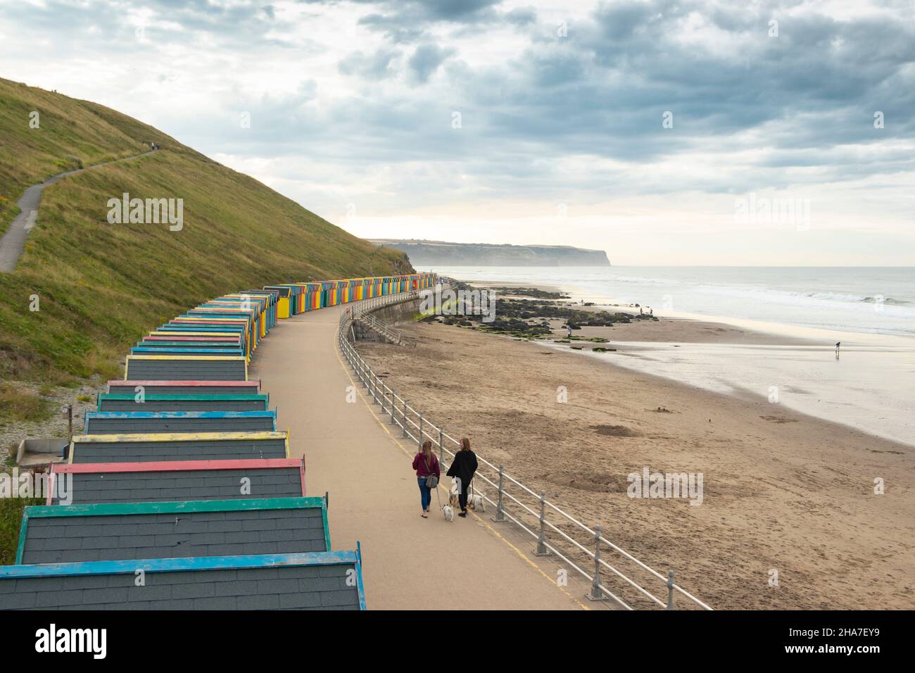 colourful row of beach huts on the seafront in Whitby North Yorkshire ...