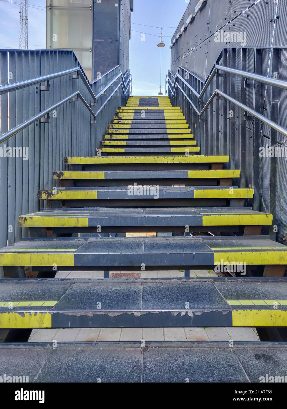View of metal stairs up with yellow signs, ladder to the ship with a ...