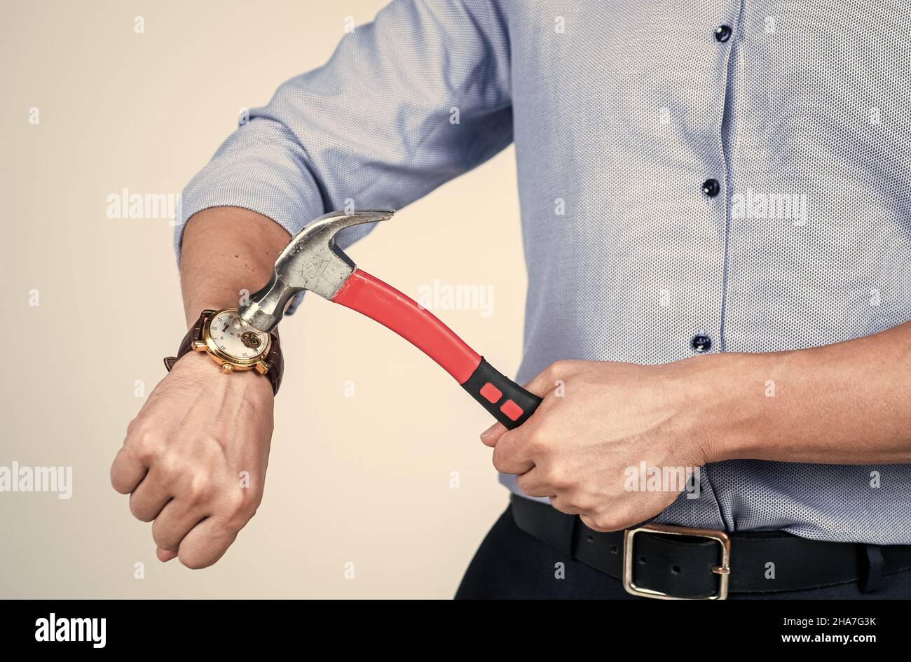 Man cropped view break wrist watch device with claw hammer tool, kill ...