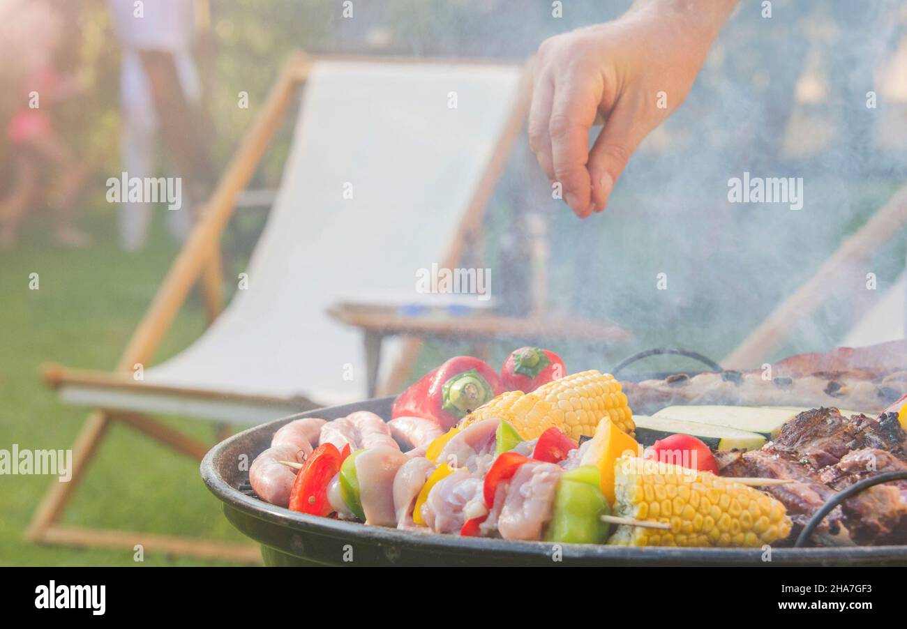 Summertime fun. Barbecue for summer family dinner in the backyard of ...