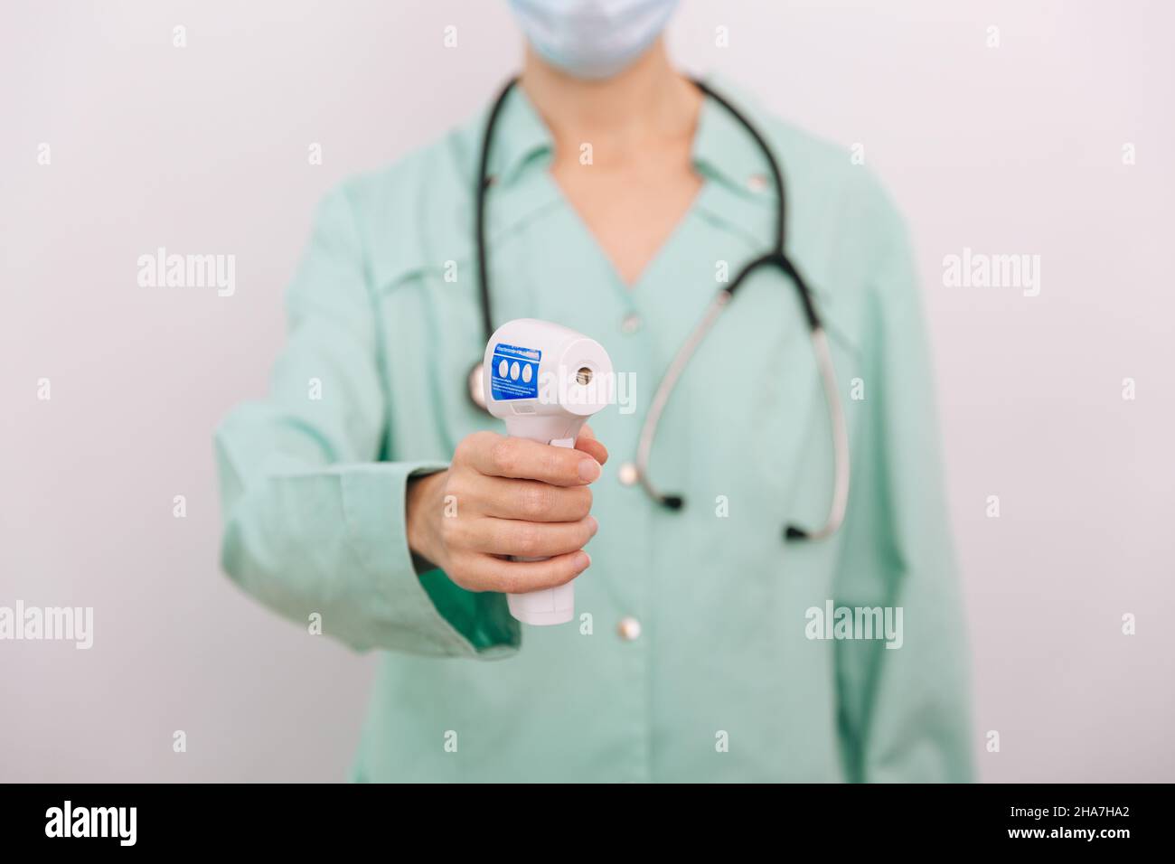 Temperature measurement gun in doctor hands. Close-up shot of doctor ...
